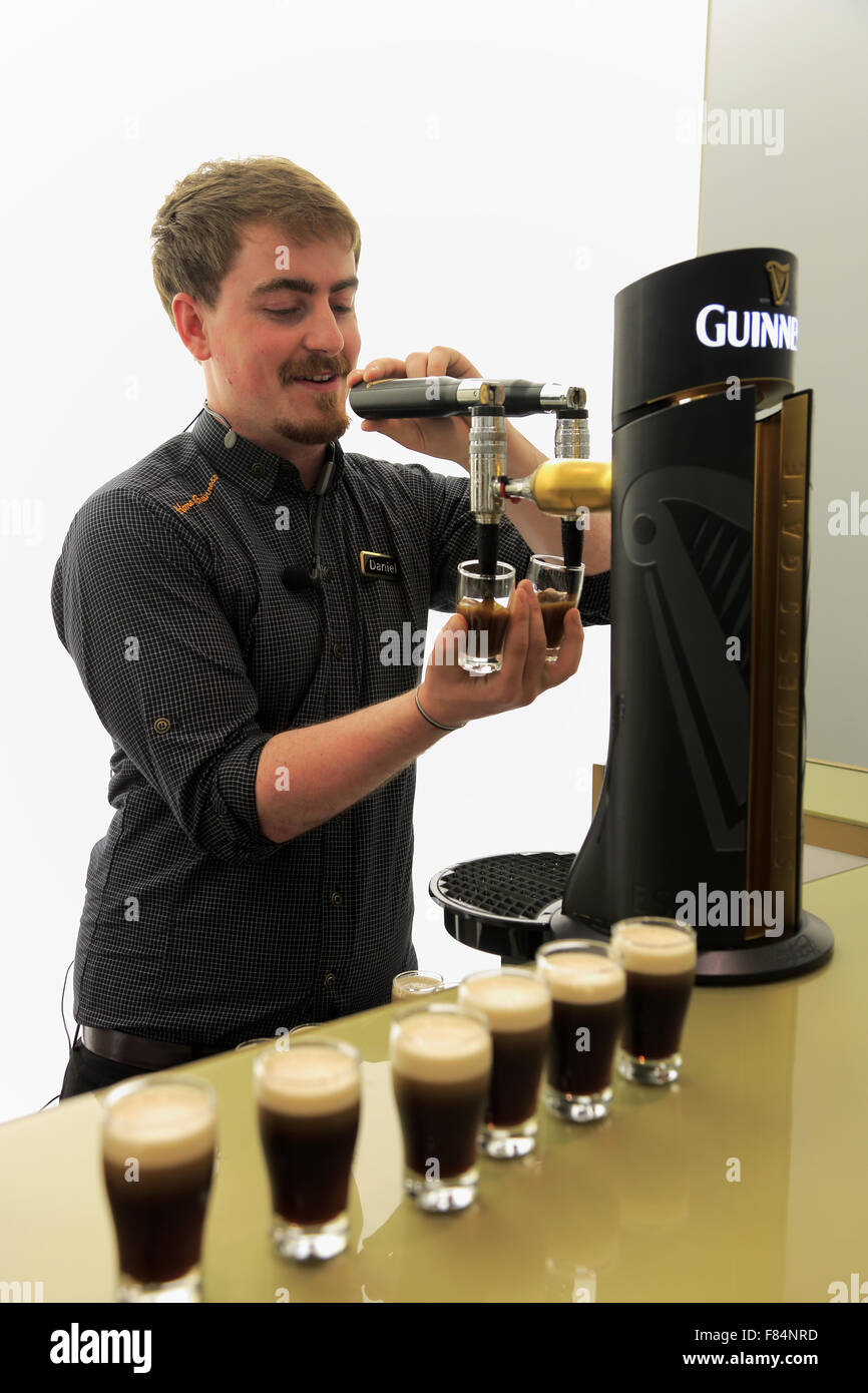 A bartender pouring Guinness beer into testing glasses in Guinness ...