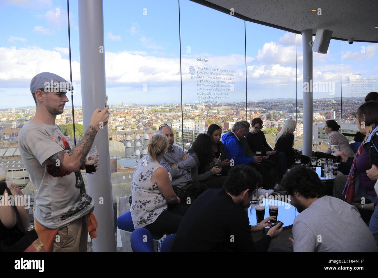 Visitors taking photos in the Gravity Bar of the Guinness Storehouse ...