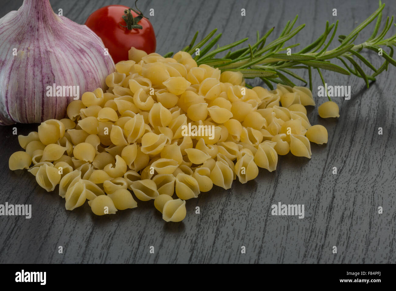 Raw shell pasta with herbs Stock Photo - Alamy
