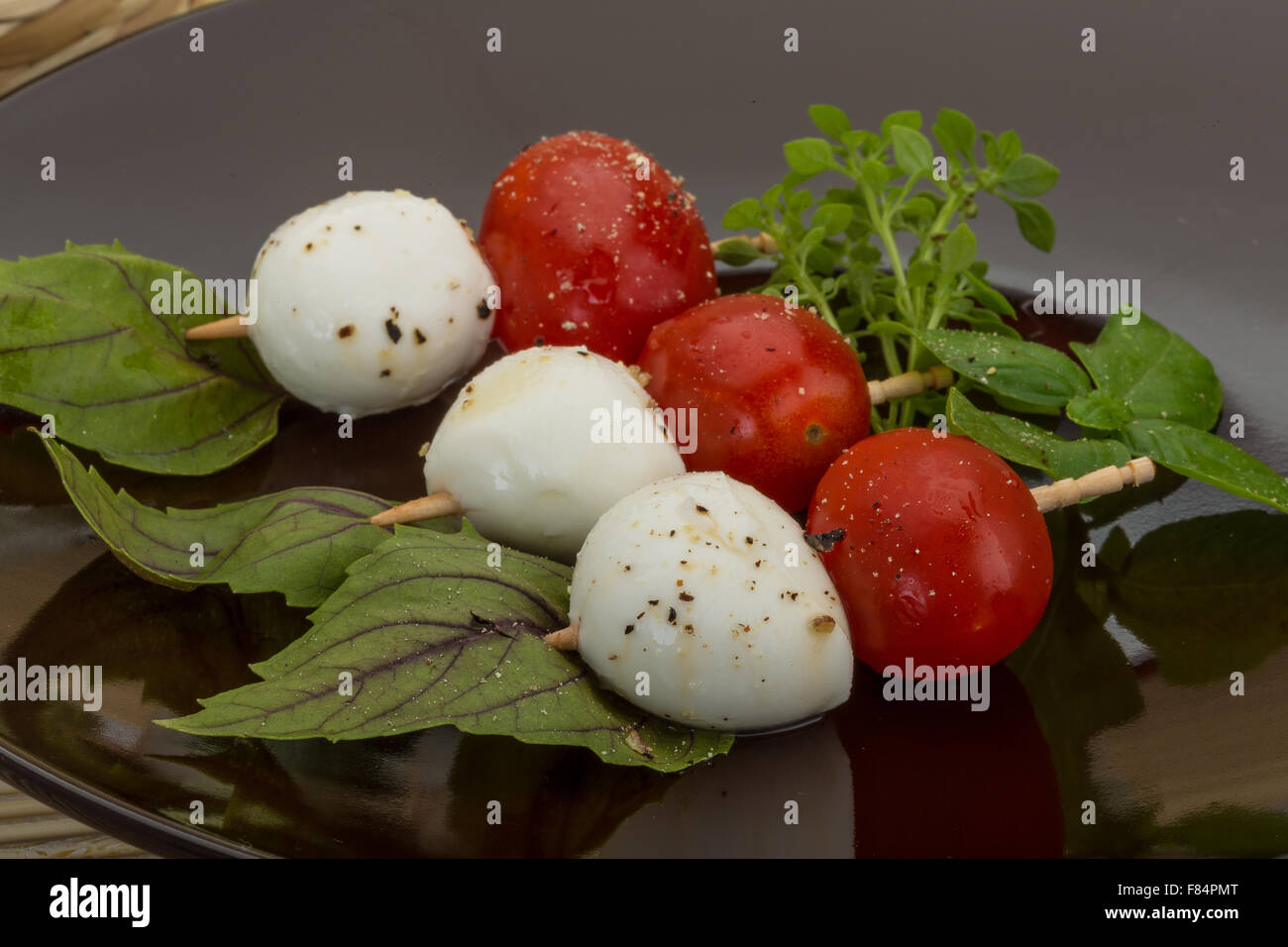 Famous italian caprese salad with fresh basil leaves Stock Photo - Alamy
