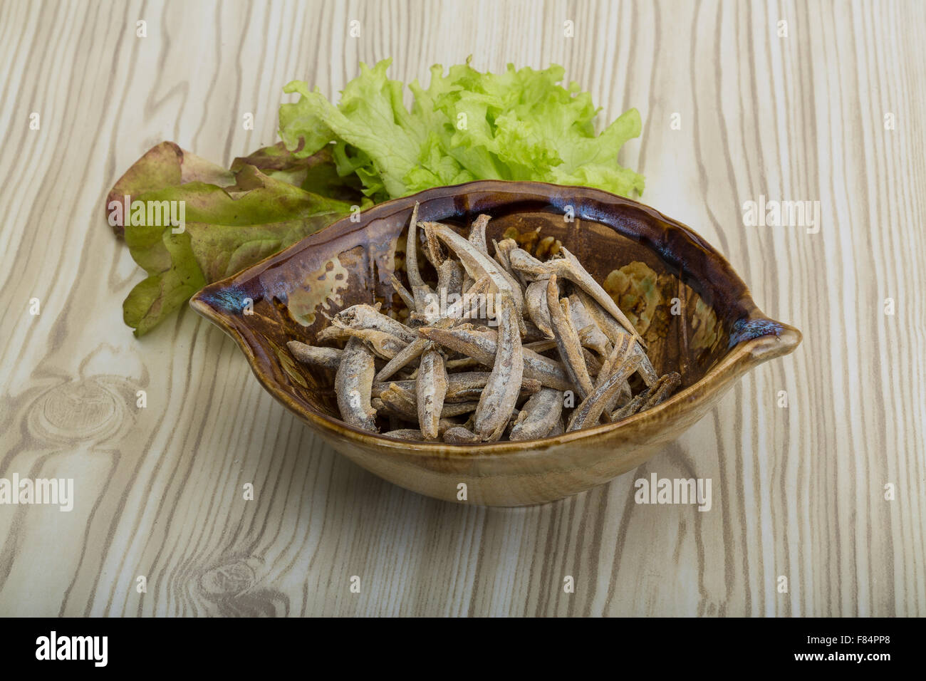 Dries anchovy - small fishes in the bowl Stock Photo - Alamy