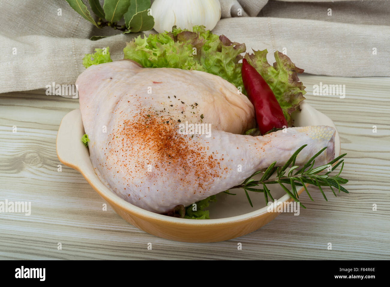 Chicken thigh with rosemary, pepper and salad leaves Stock Photo - Alamy