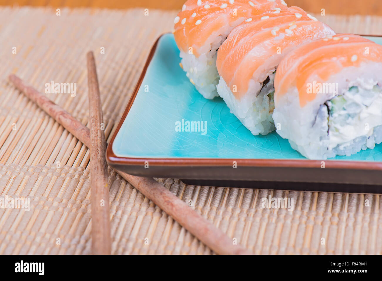 California maki sushi with fish and chopsticks Stock Photo - Alamy