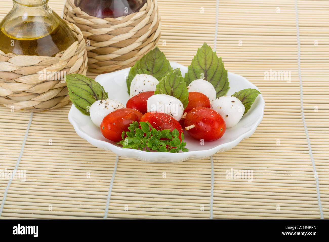 Famous italian caprese salad with fresh basil leaves Stock Photo - Alamy