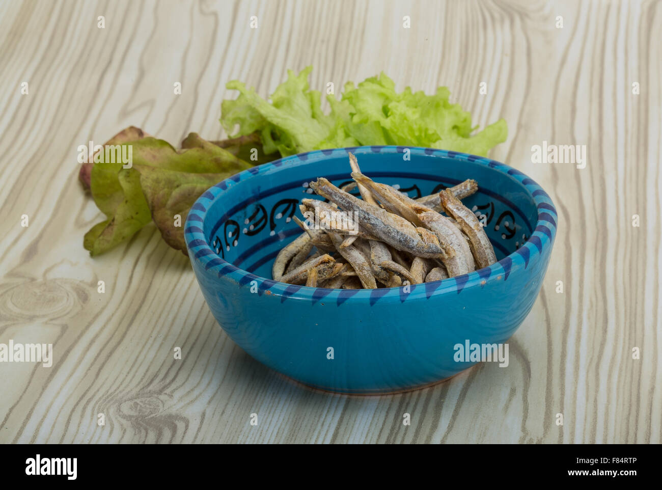 Dries anchovy - small fishes in the bowl Stock Photo - Alamy