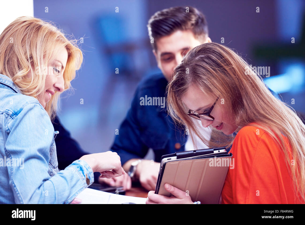 students group working on school project together on tablet computer at ...