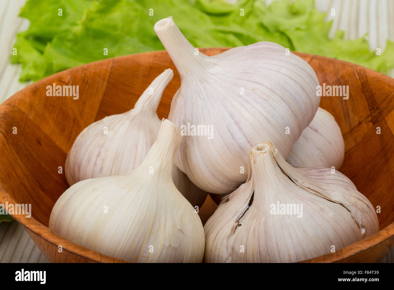 Heap of garlick - on the wooden background Stock Photo - Alamy