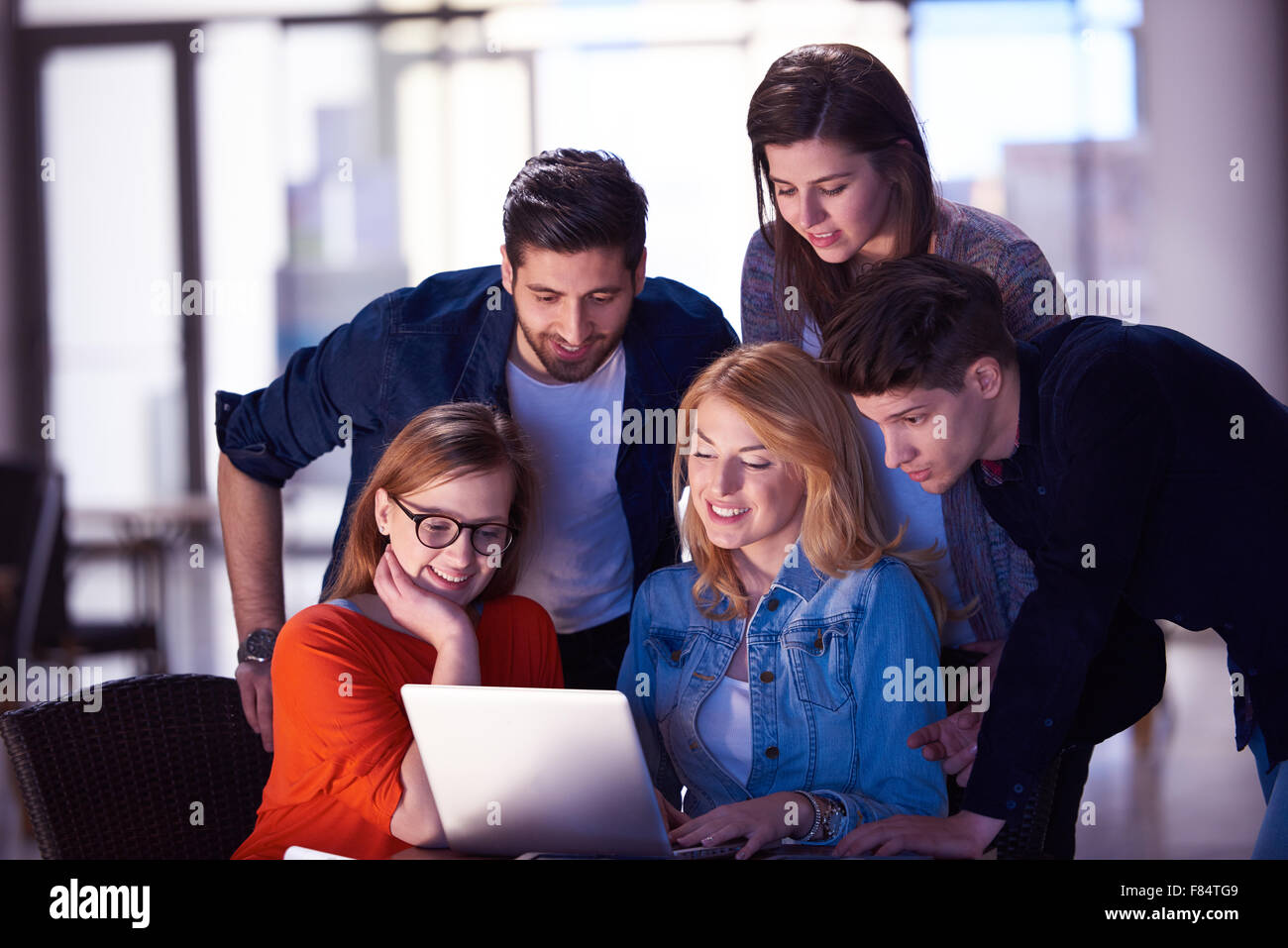 students group working on school project together on tablet computer at ...