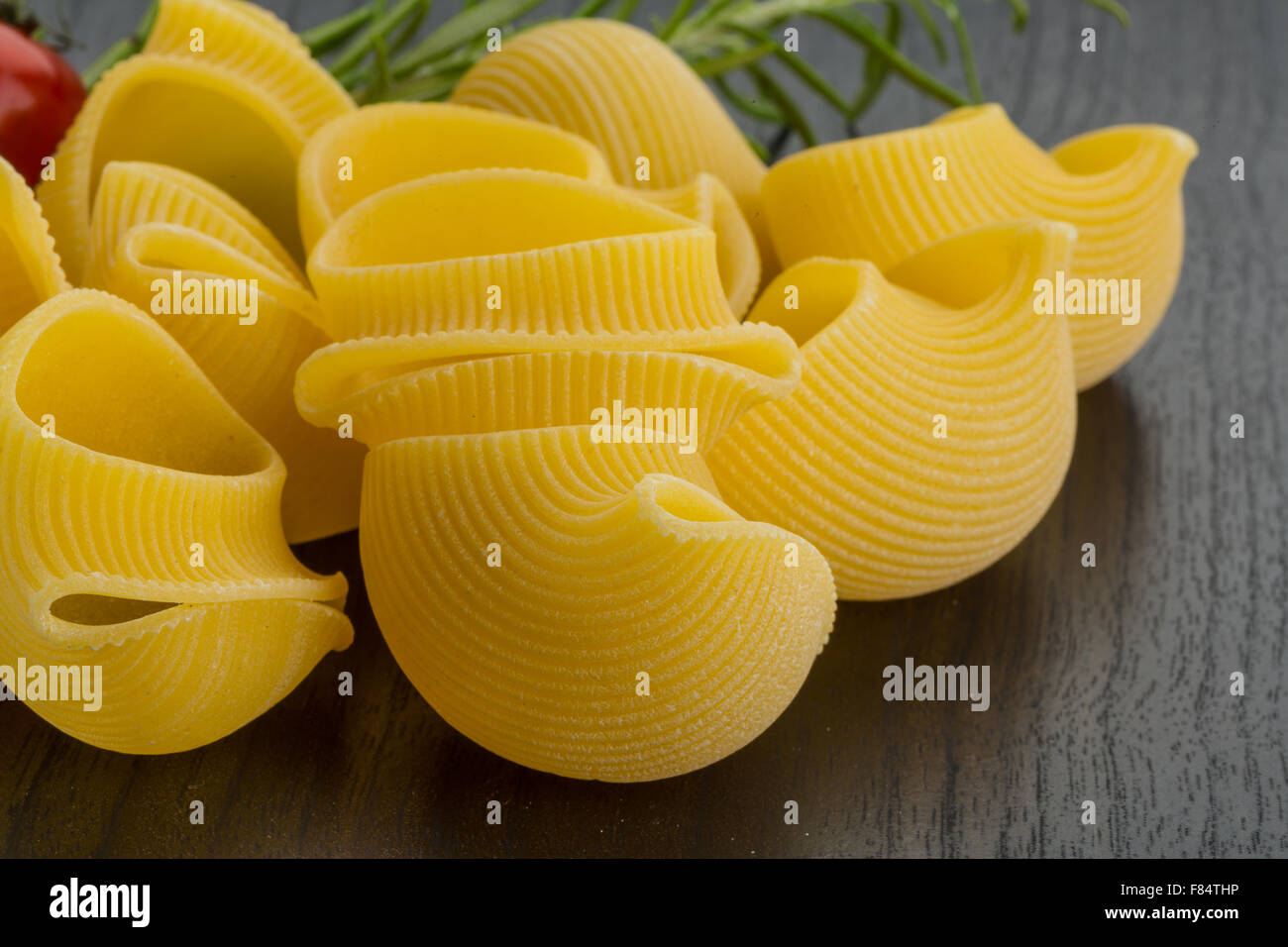 Raw shell pasta with herbs Stock Photo - Alamy