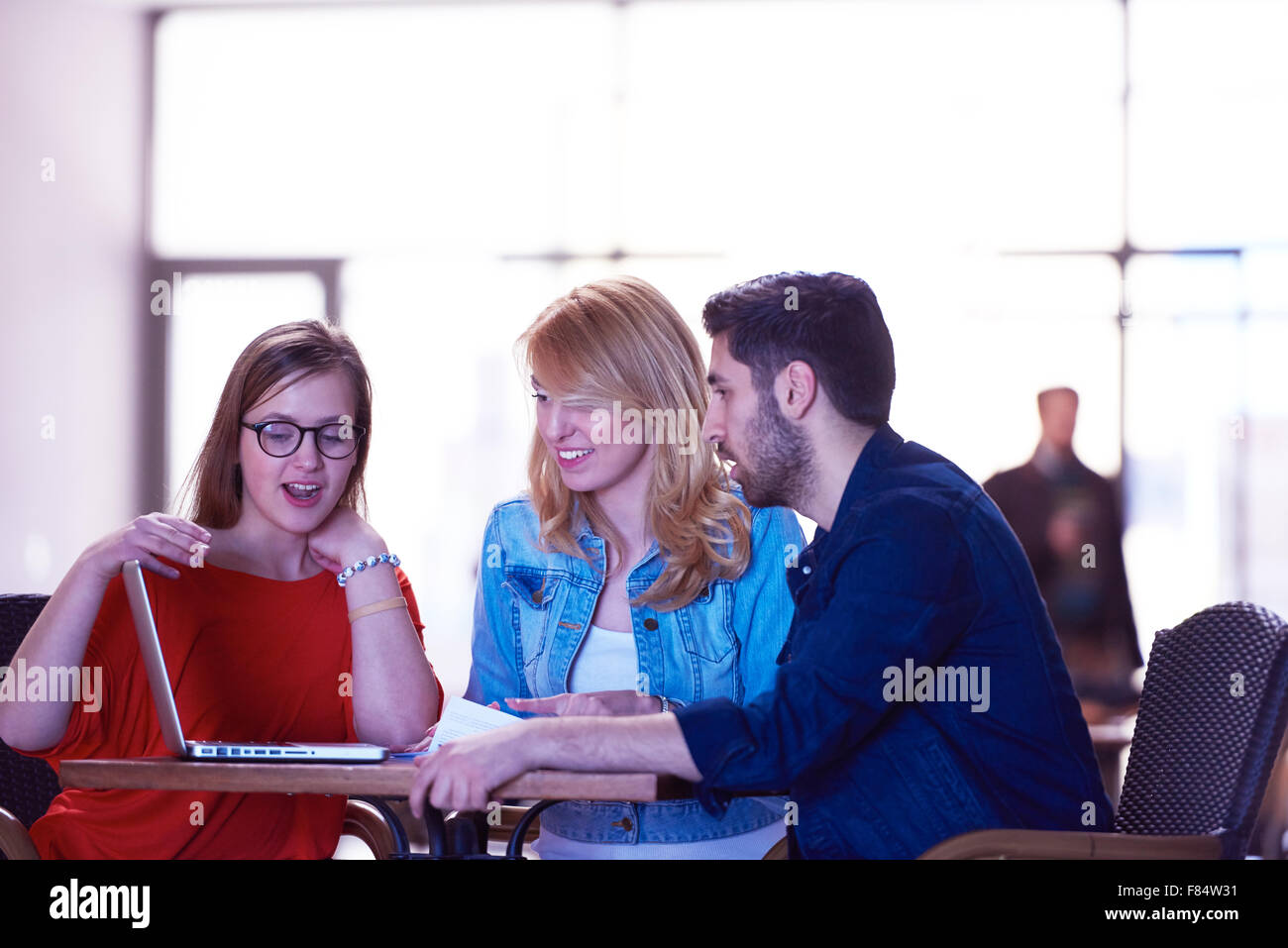 students group working on school project together on tablet computer at ...