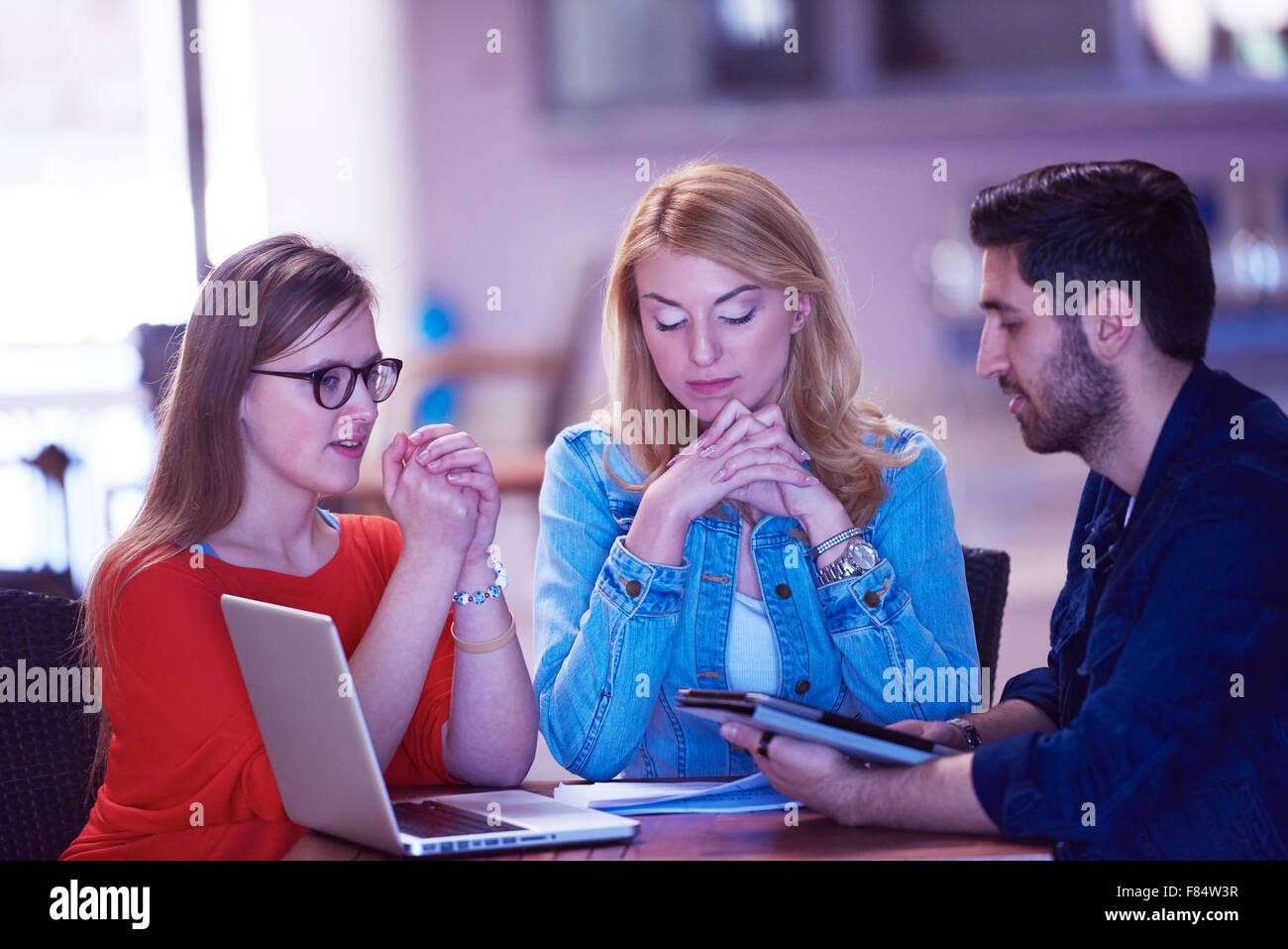 students group working on school project together on tablet computer at ...