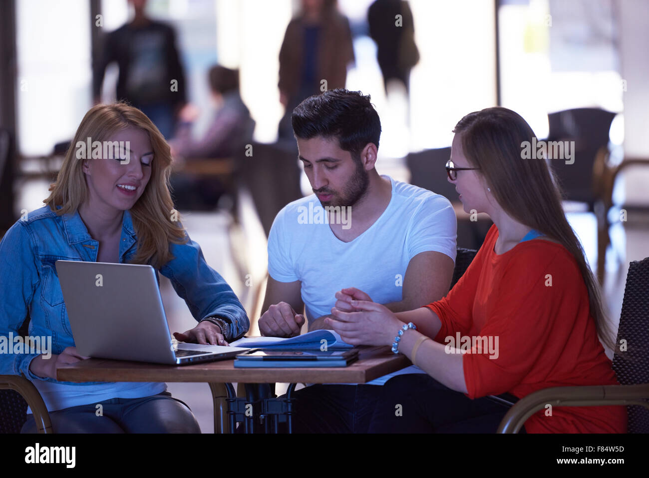 students group working on school project together on tablet computer at ...