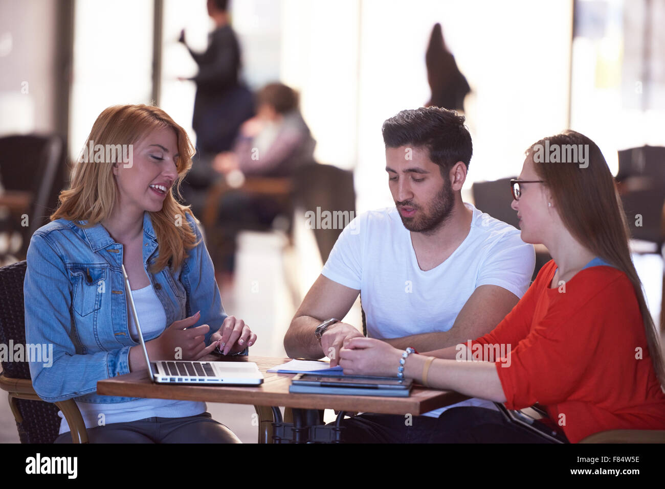 students group working on school project together on tablet computer at ...