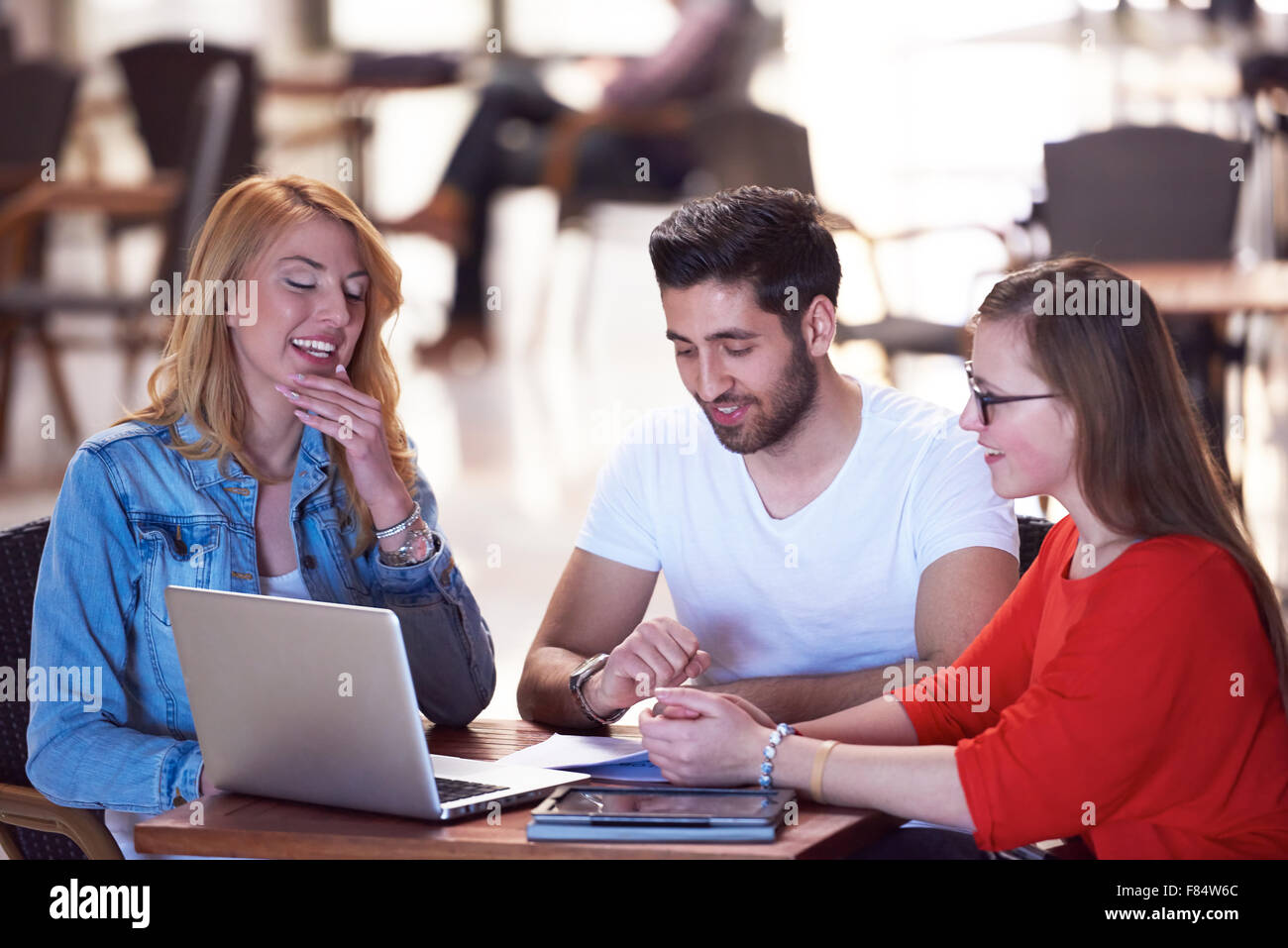 students group working on school project together on tablet computer at ...