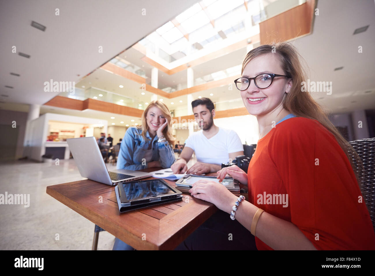 students group working on school project together on tablet computer at ...