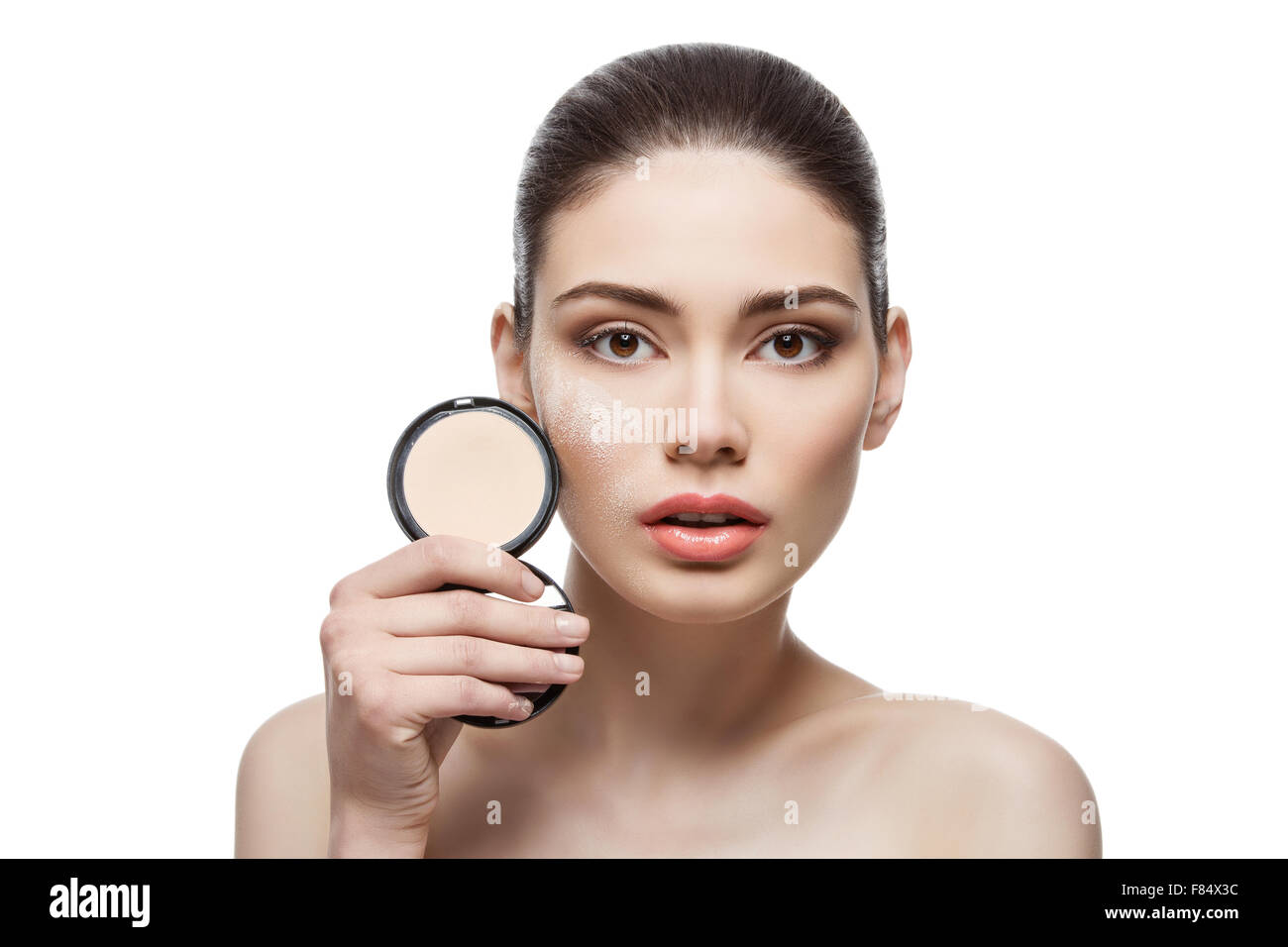 Beautiful girl holding pressed powder Stock Photo - Alamy