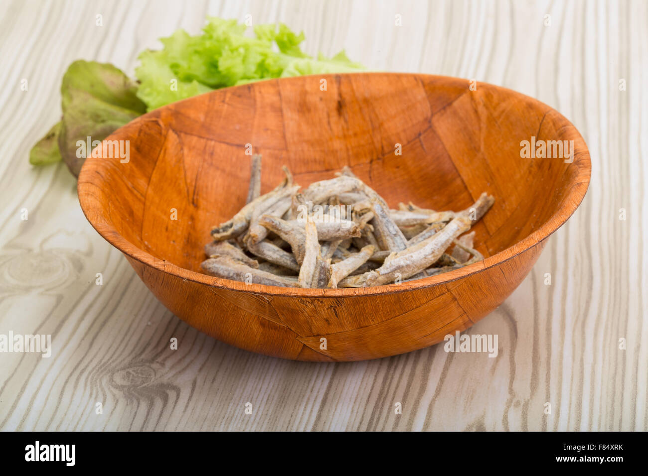 Dries anchovy - small fishes in the bowl Stock Photo - Alamy