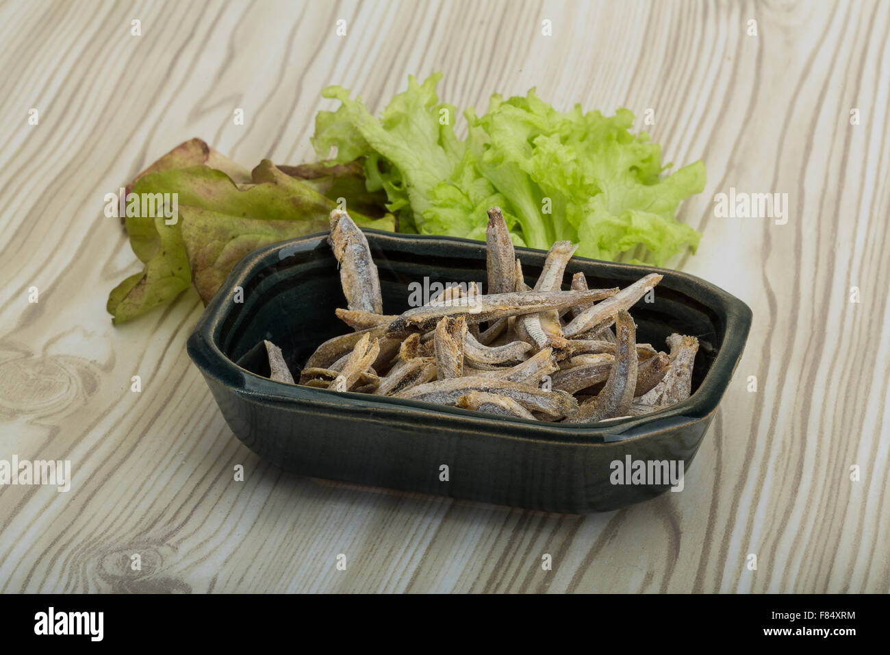 Dries anchovy - small fishes in the bowl Stock Photo - Alamy