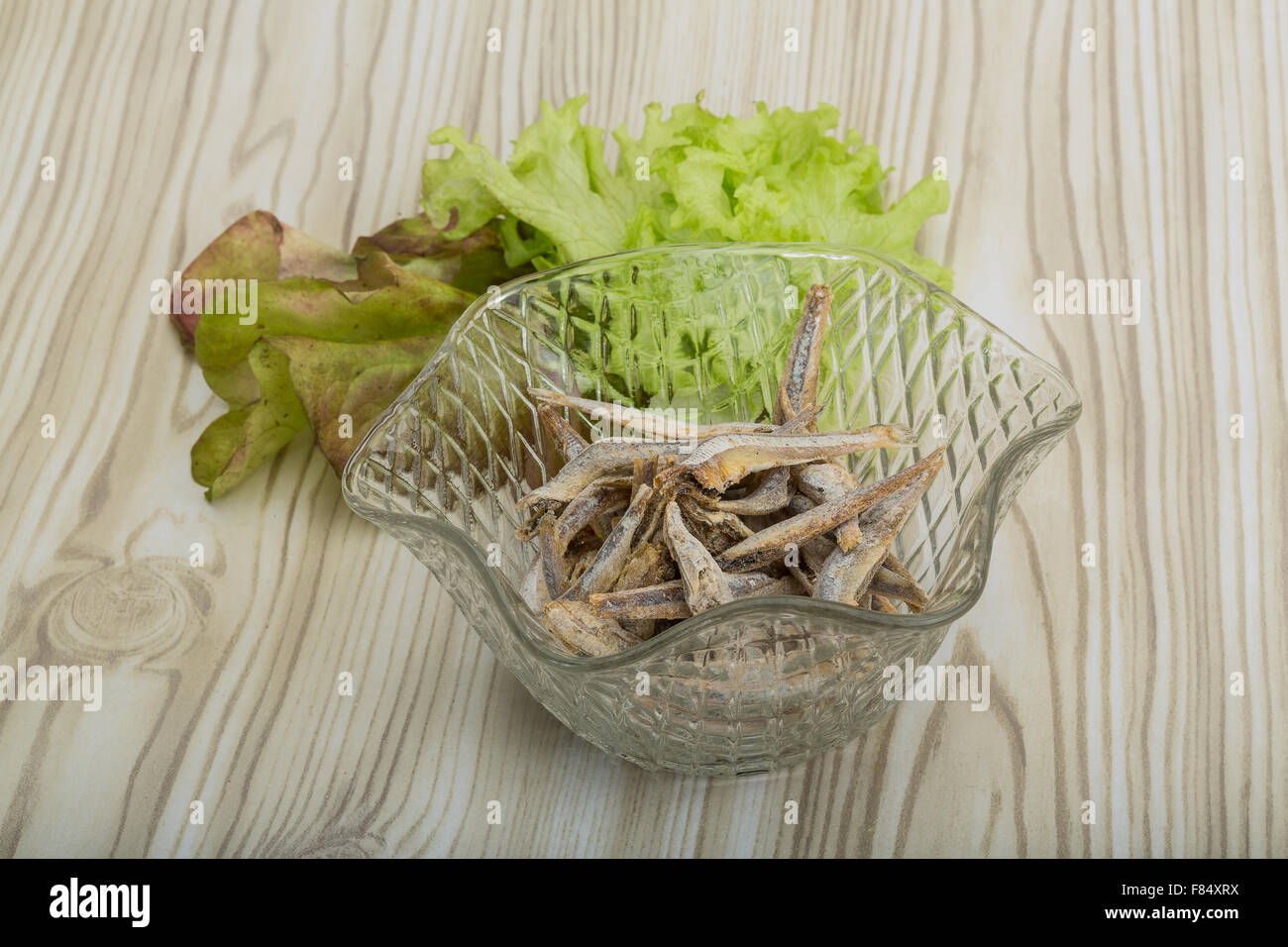 Dries anchovy - small fishes in the bowl Stock Photo - Alamy