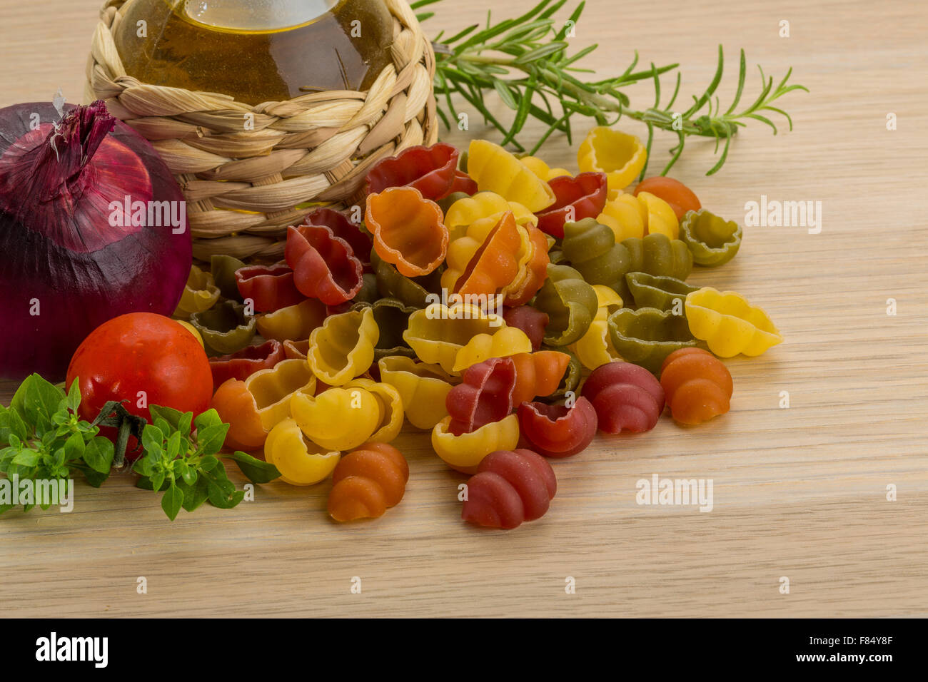 Raw macaroni - shell pasta with herbs Stock Photo - Alamy