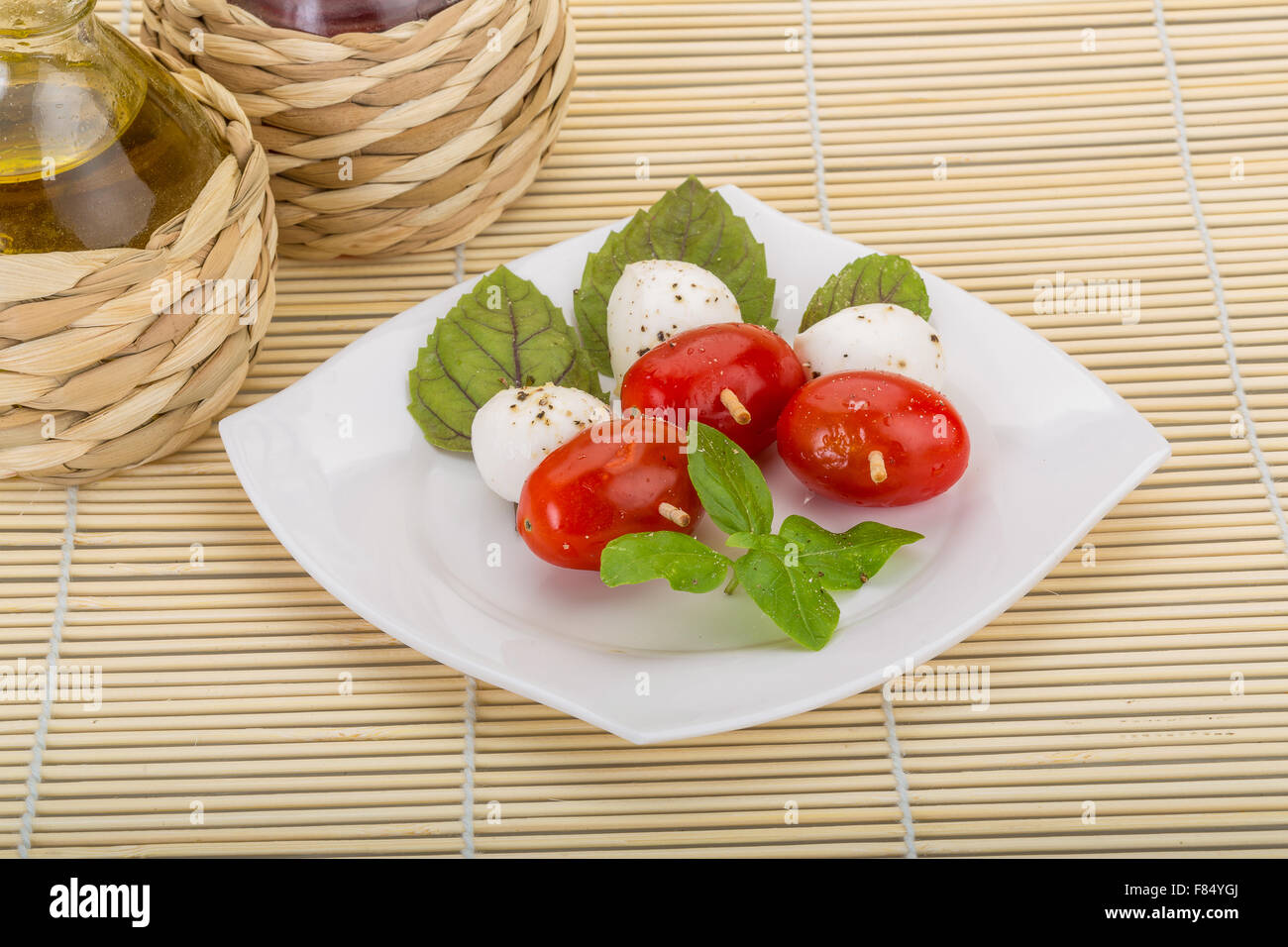 Famous italian caprese salad with fresh basil leaves Stock Photo - Alamy