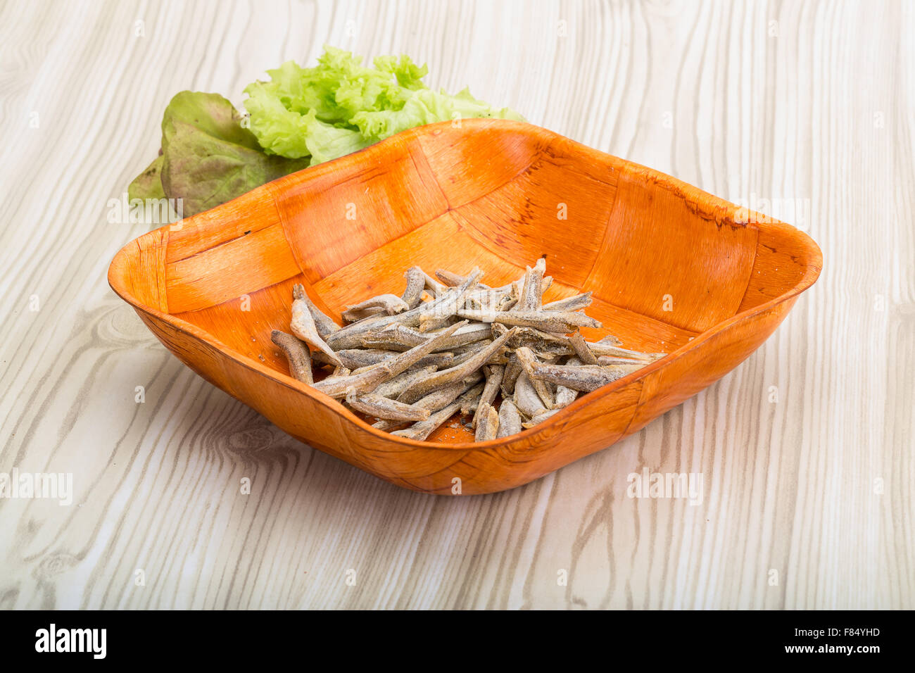 Dries anchovy - small fishes in the bowl Stock Photo - Alamy