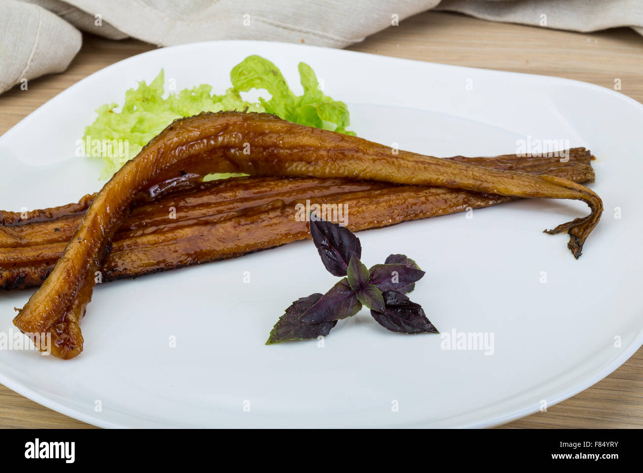 Smoked eel with salad leaves and basil Stock Photo - Alamy
