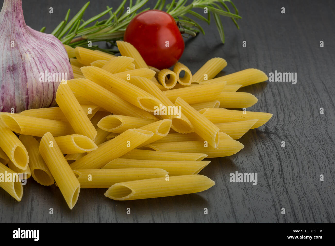 Penne - raw italian pasta with herbs Stock Photo - Alamy
