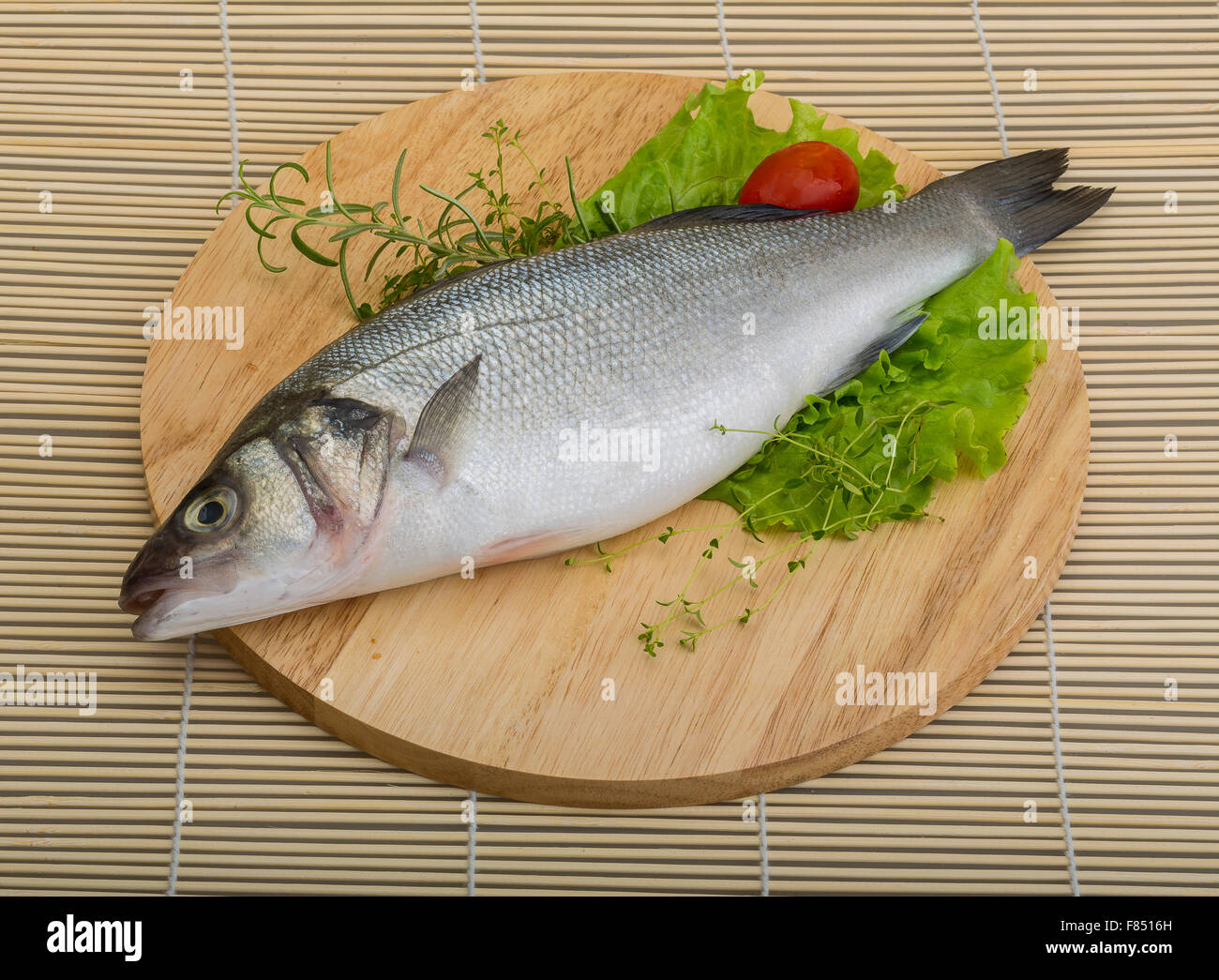 Raw seabass fish with herbs - ready for cooking Stock Photo - Alamy