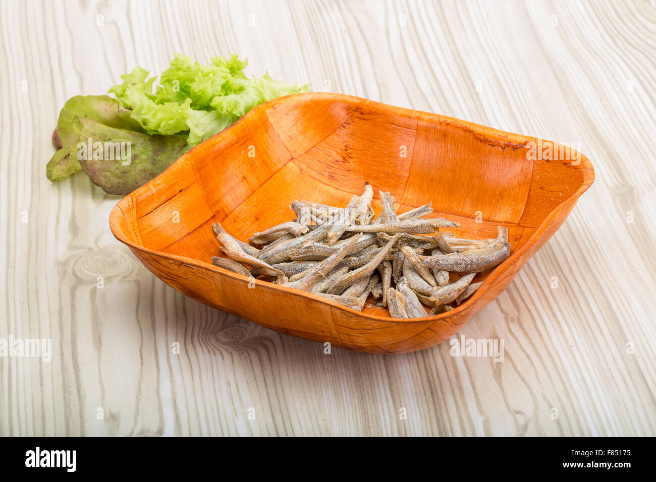 Dries anchovy - small fishes in the bowl Stock Photo - Alamy