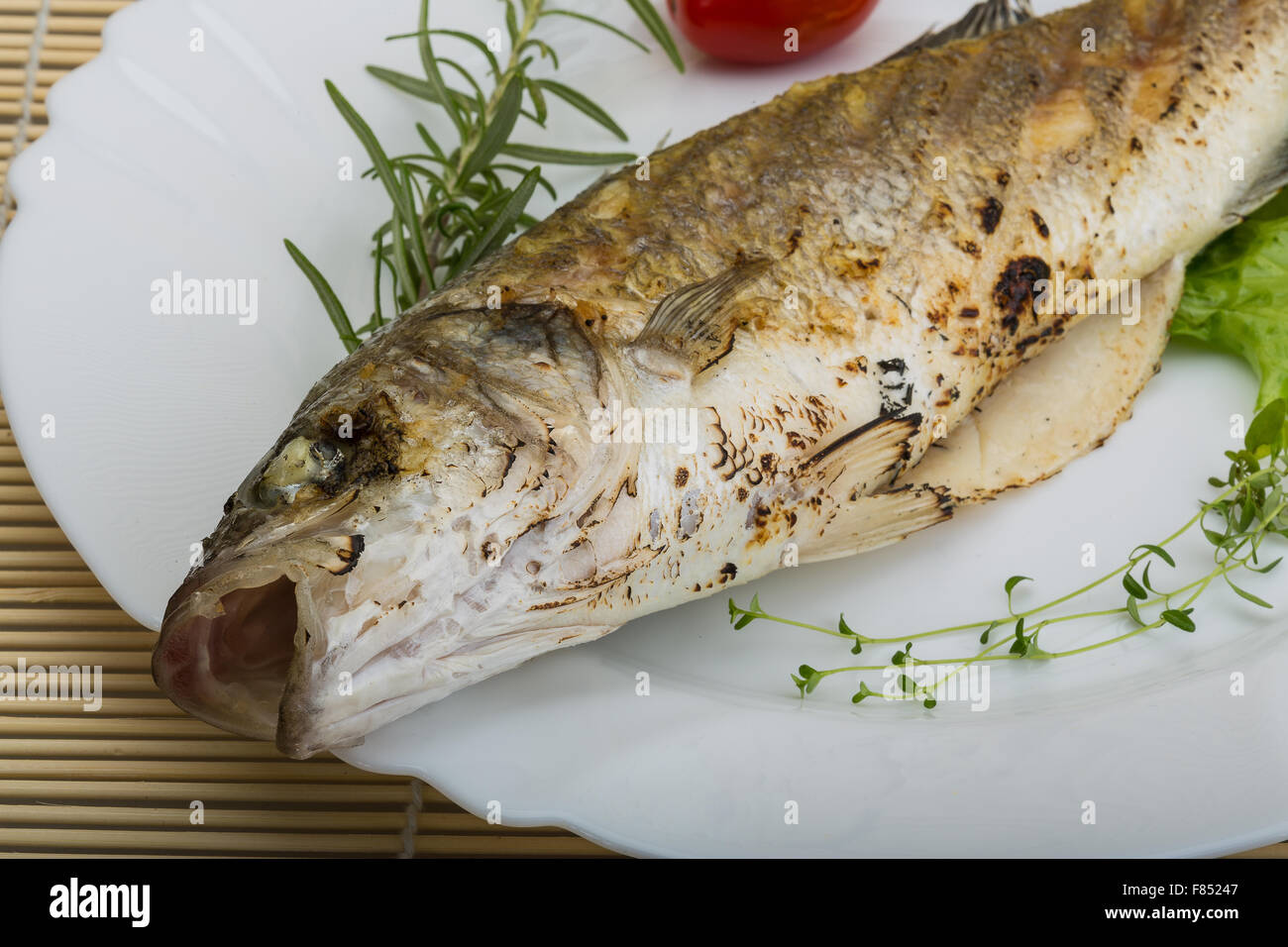 Grilled seabass fish - with rosemary and thyme Stock Photo - Alamy