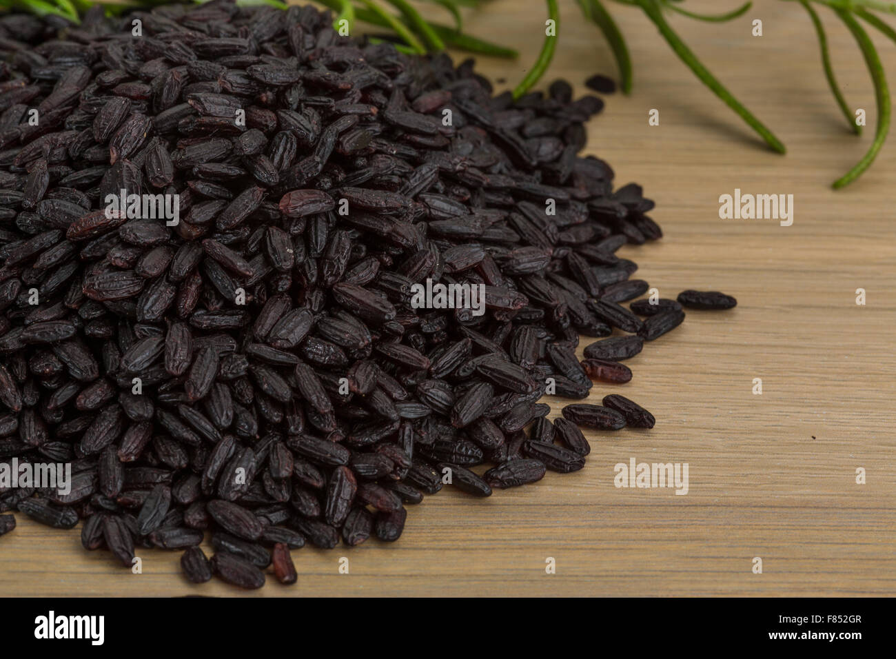 Raw black rice with herbs Stock Photo - Alamy