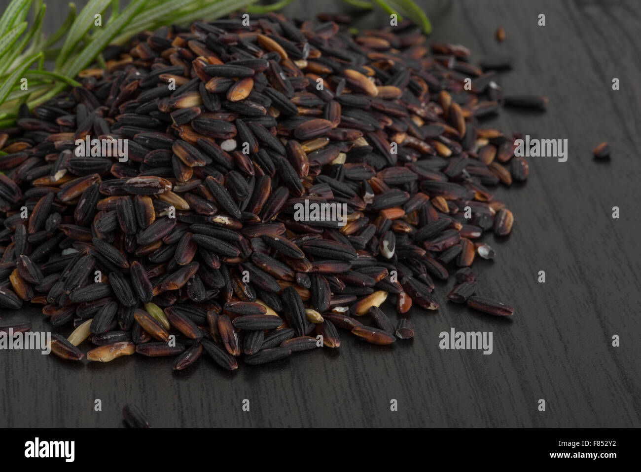 Raw wild rice with herbs Stock Photo - Alamy