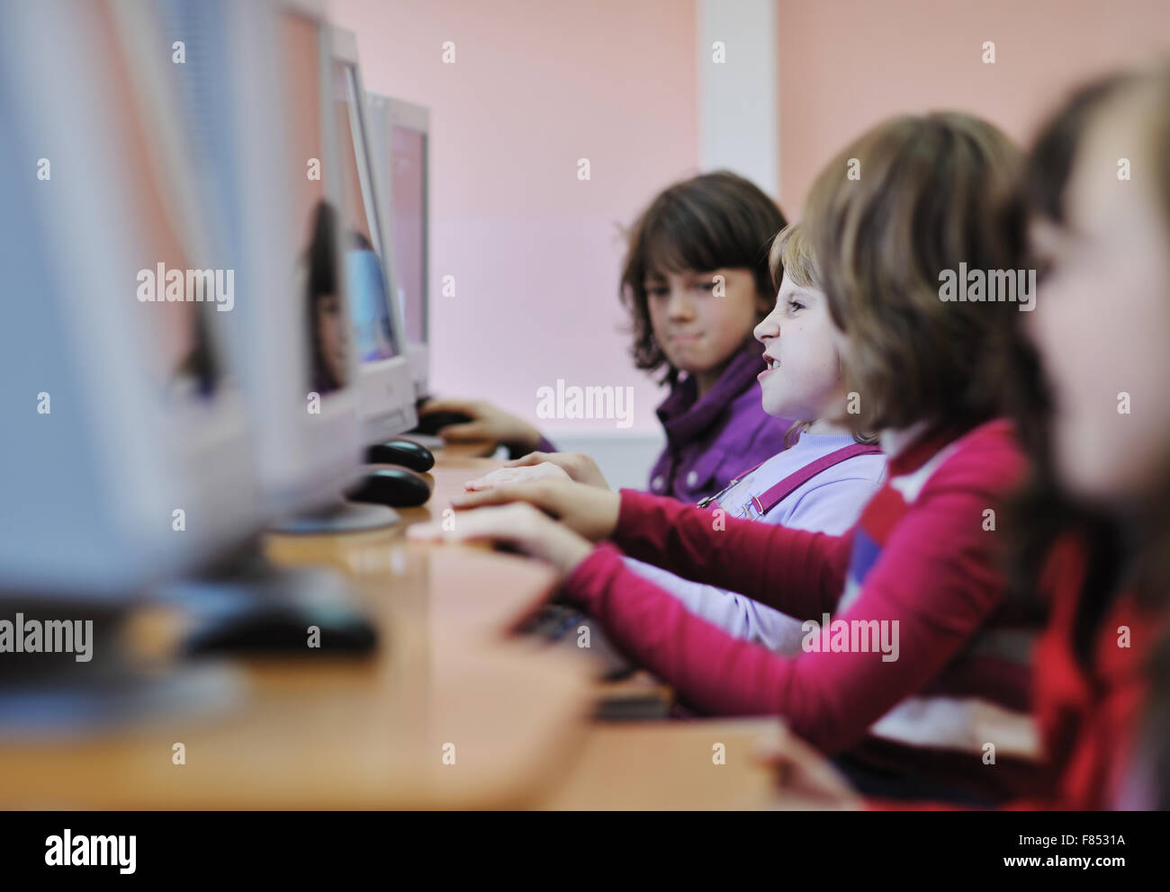 it education with children group in school at computer science class ...