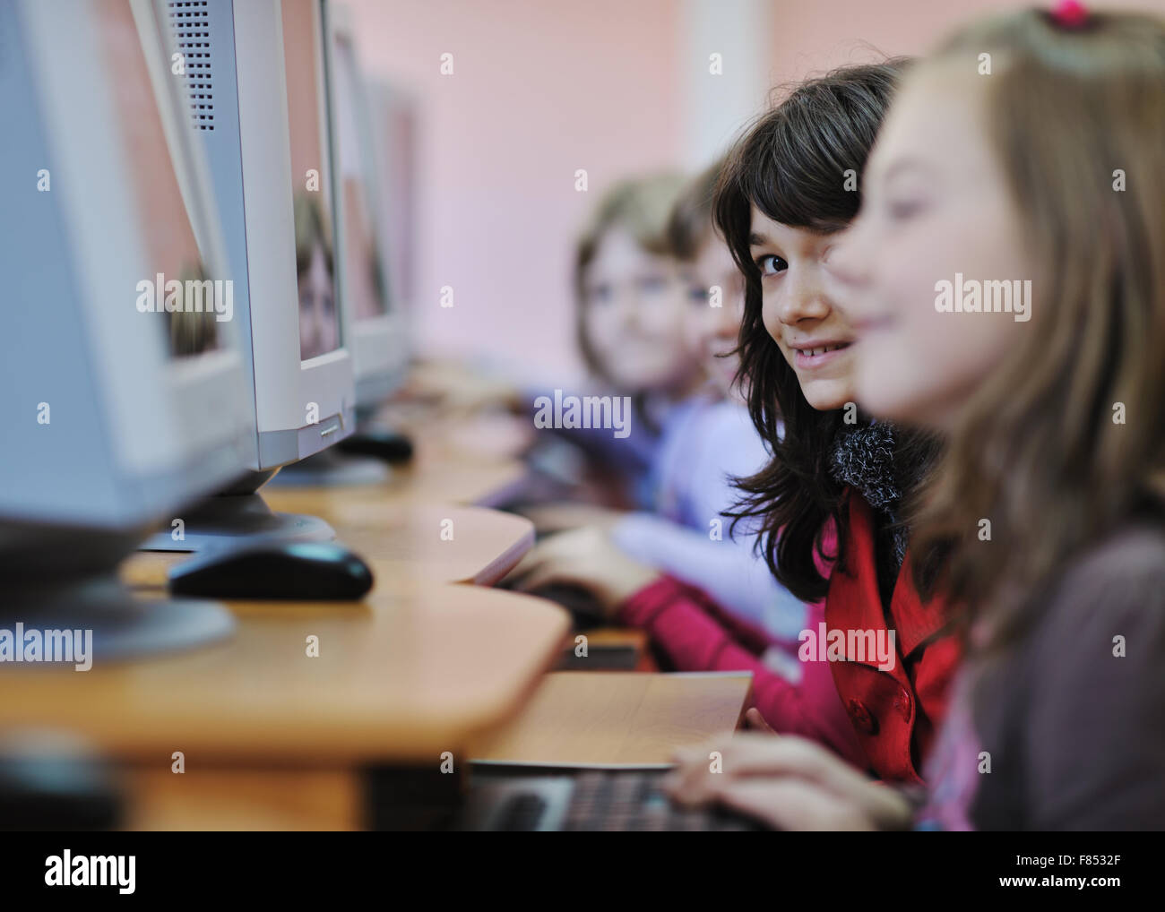 it education with children group in school at computer science class ...