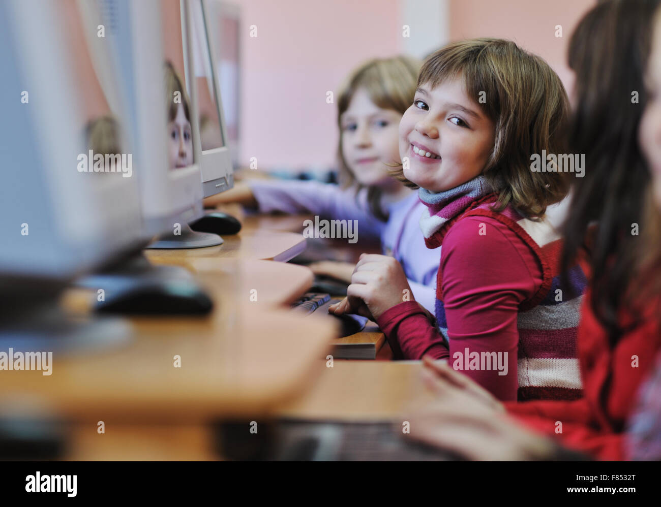 it education with children group in school at computer science class ...