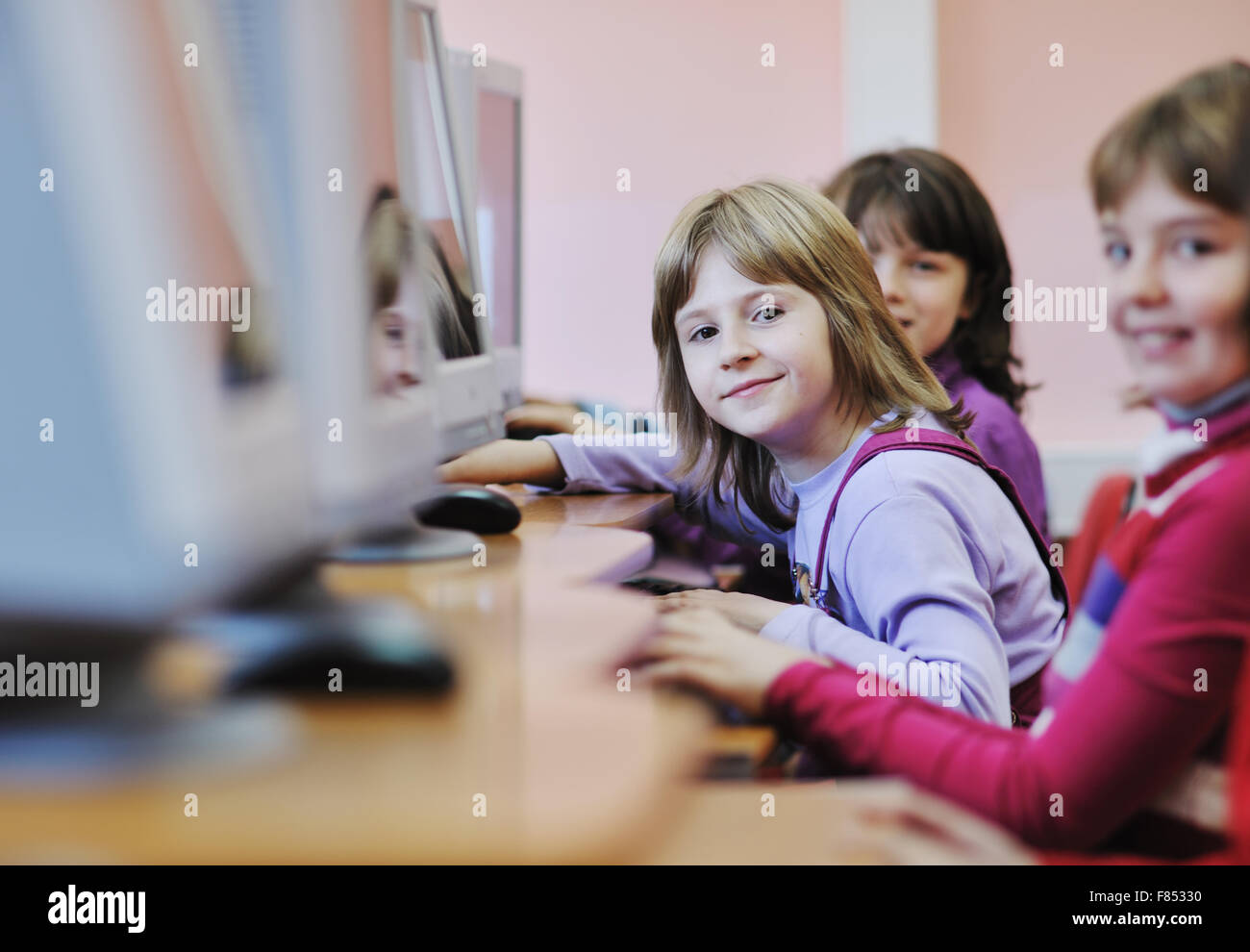 it education with children group in school at computer science class ...