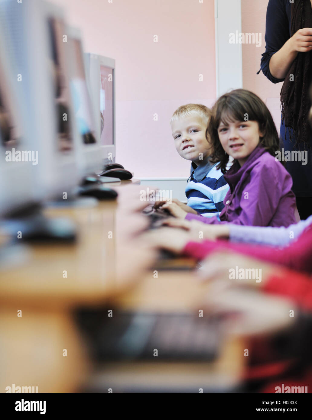 it education with children group in school at computer science class ...