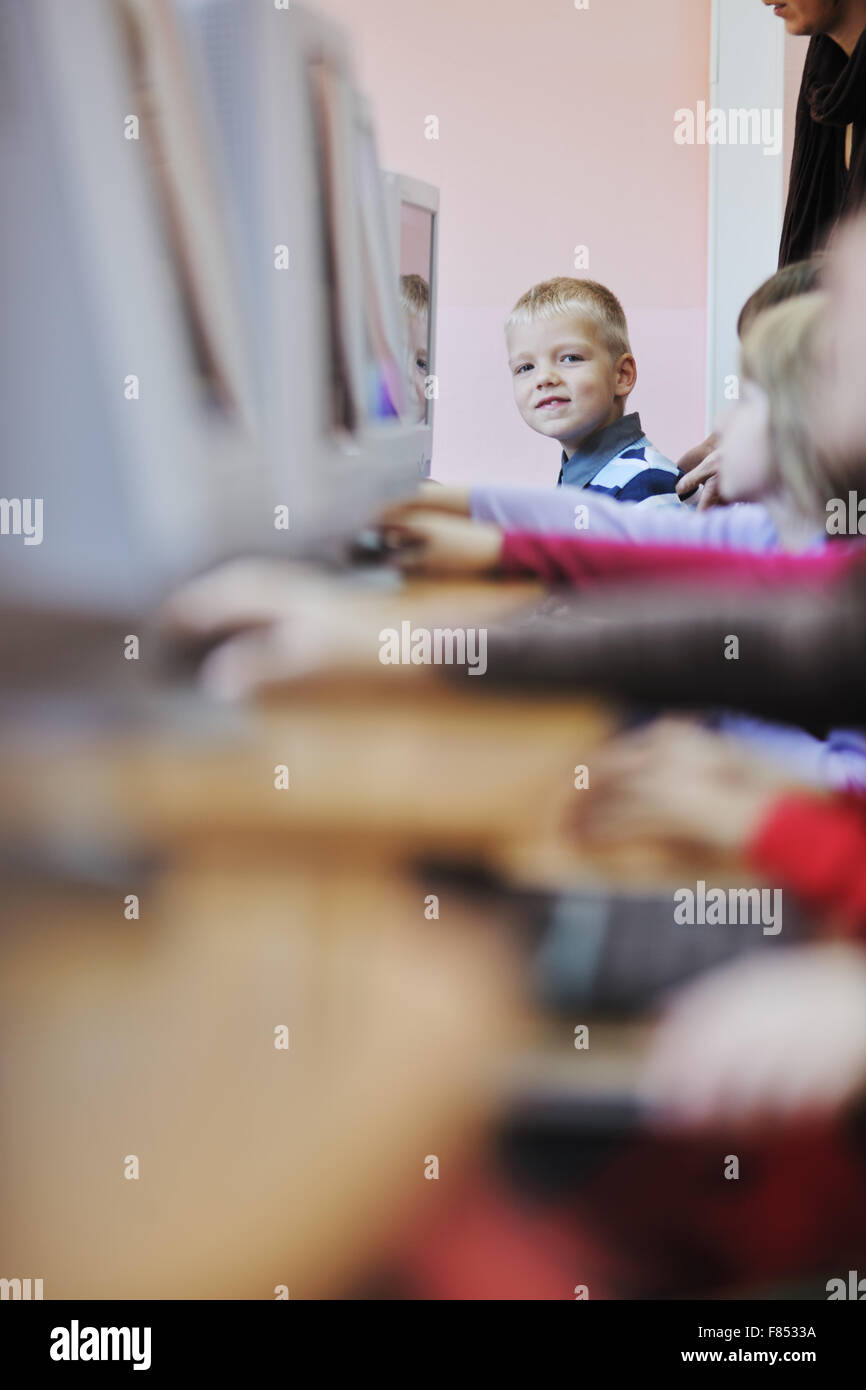 it education with children group in school at computer science class ...