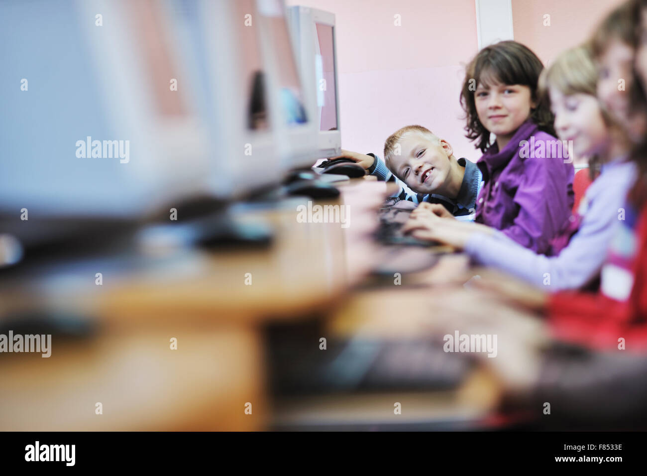 it education with children group in school at computer science class ...