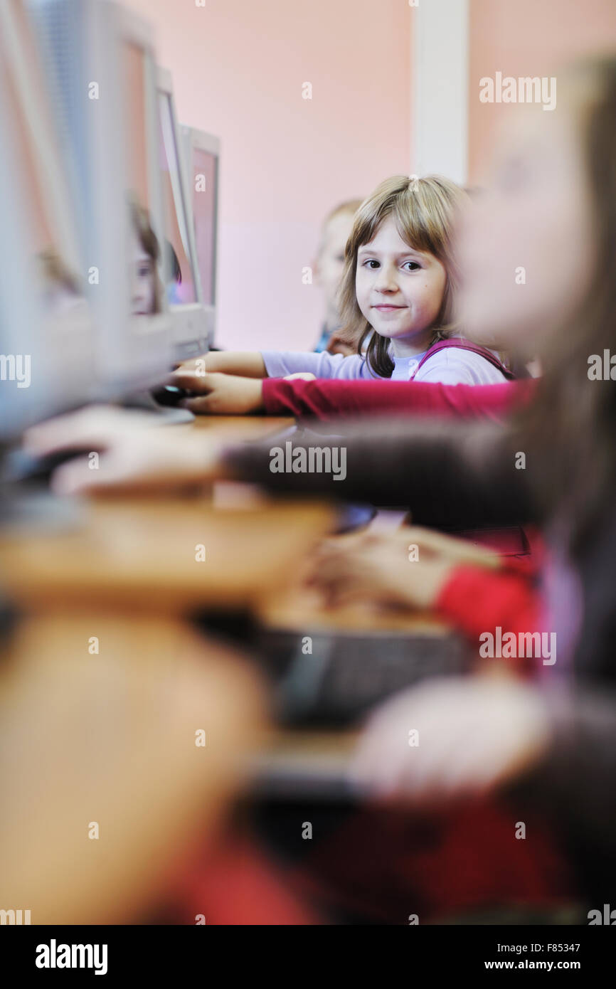 it education with children group in school at computer science class ...
