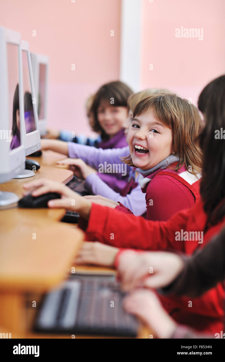 it education with children group in school at computer science class ...