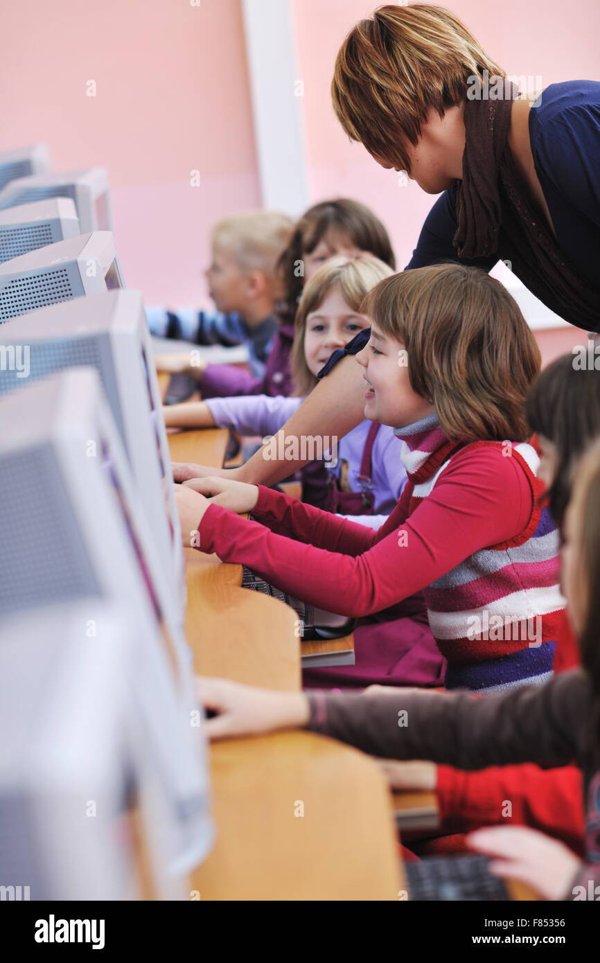 it education with children group in school at computer science class ...