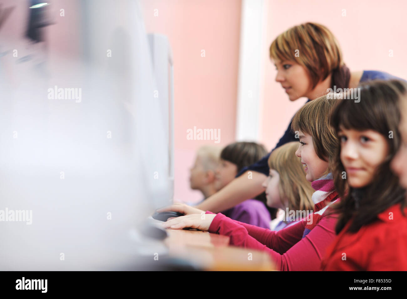 it education with children group in school at computer science class ...