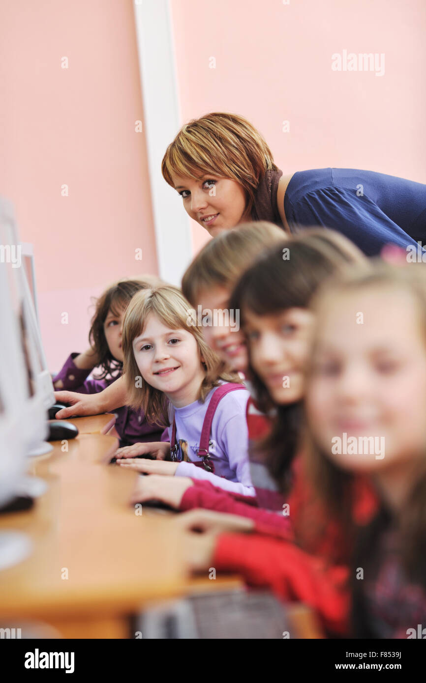 it education with children group in school at computer science class ...