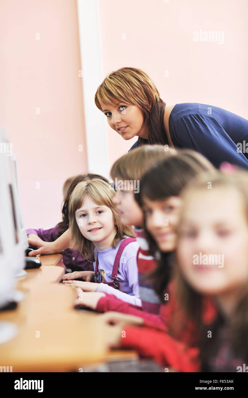 it education with children group in school at computer science class ...