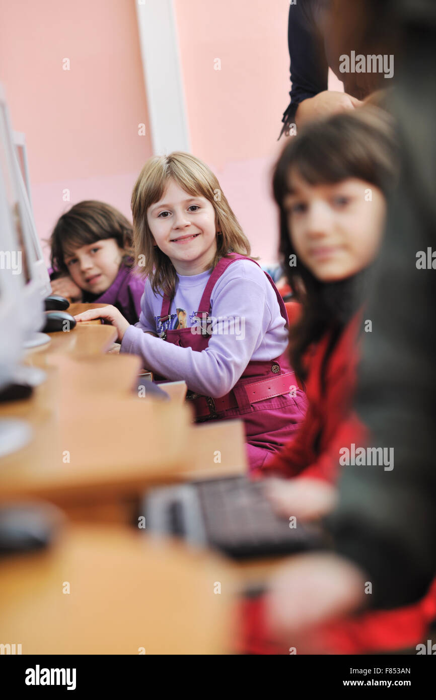 it education with children group in school at computer science class ...