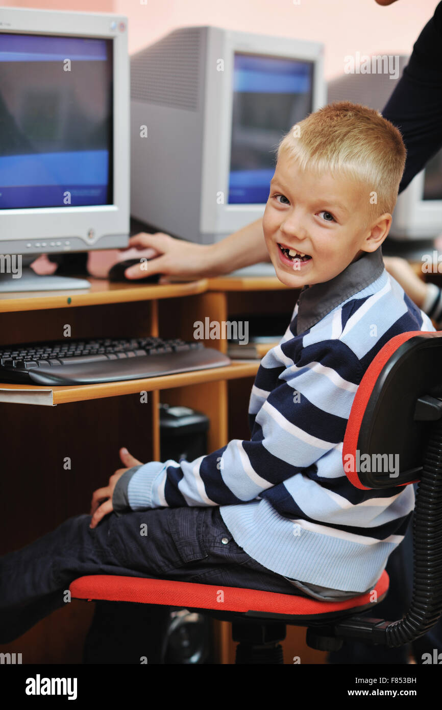 it education with children group in school at computer science class ...