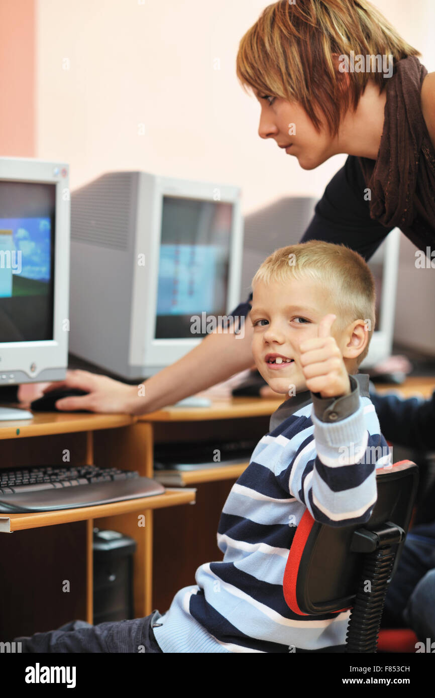 it education with children group in school at computer science class ...