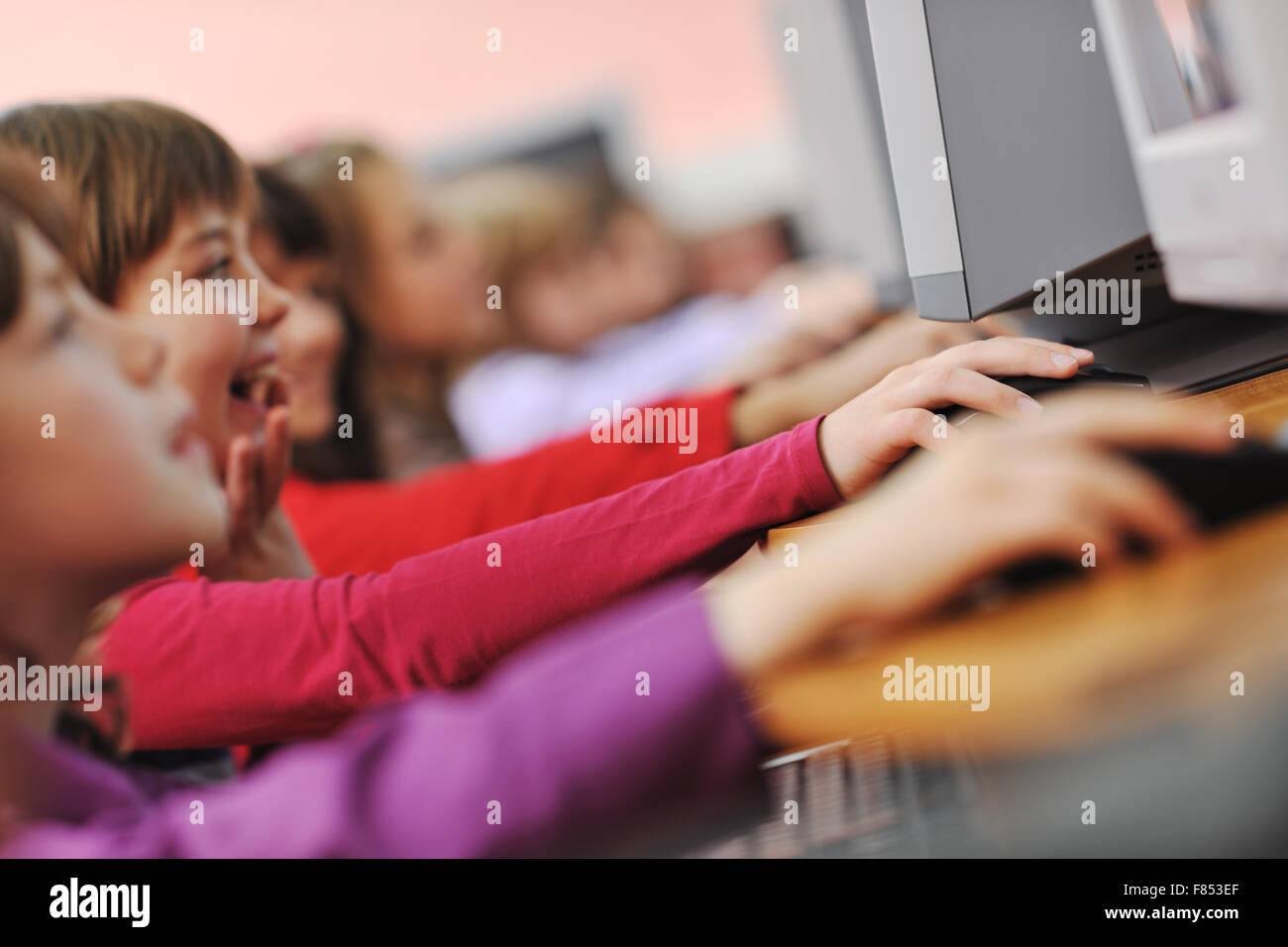 it education with children group in school at computer science class ...